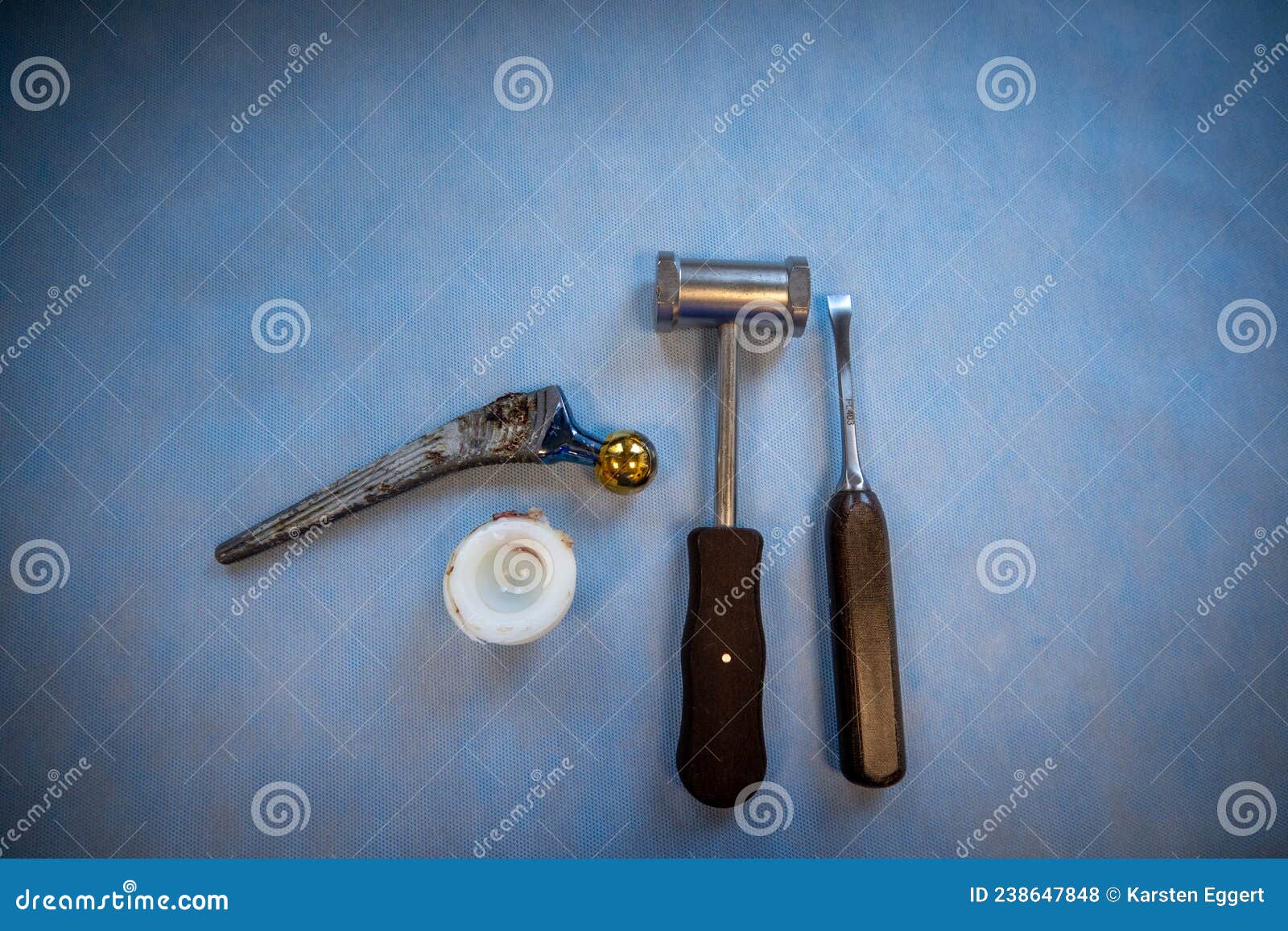 Complete Explanted Hip Prosthesis Lies Next To a Hammer and a Chisel ...