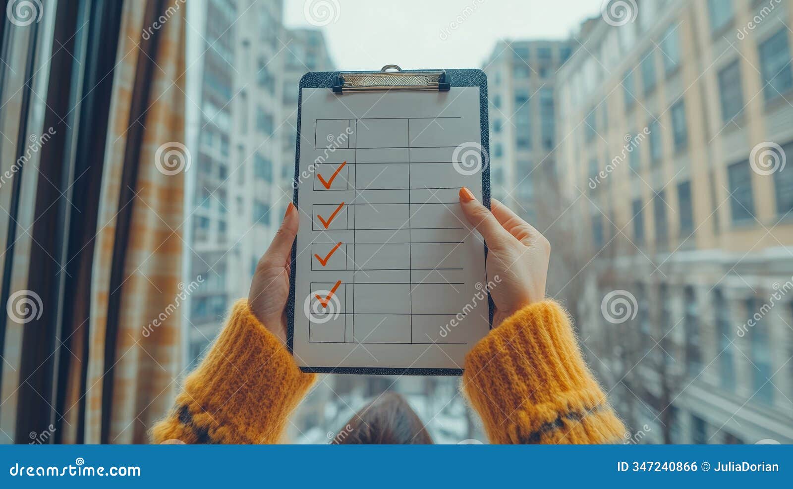 Completed Checklist with Orange Check Marks Held Against City View ...
