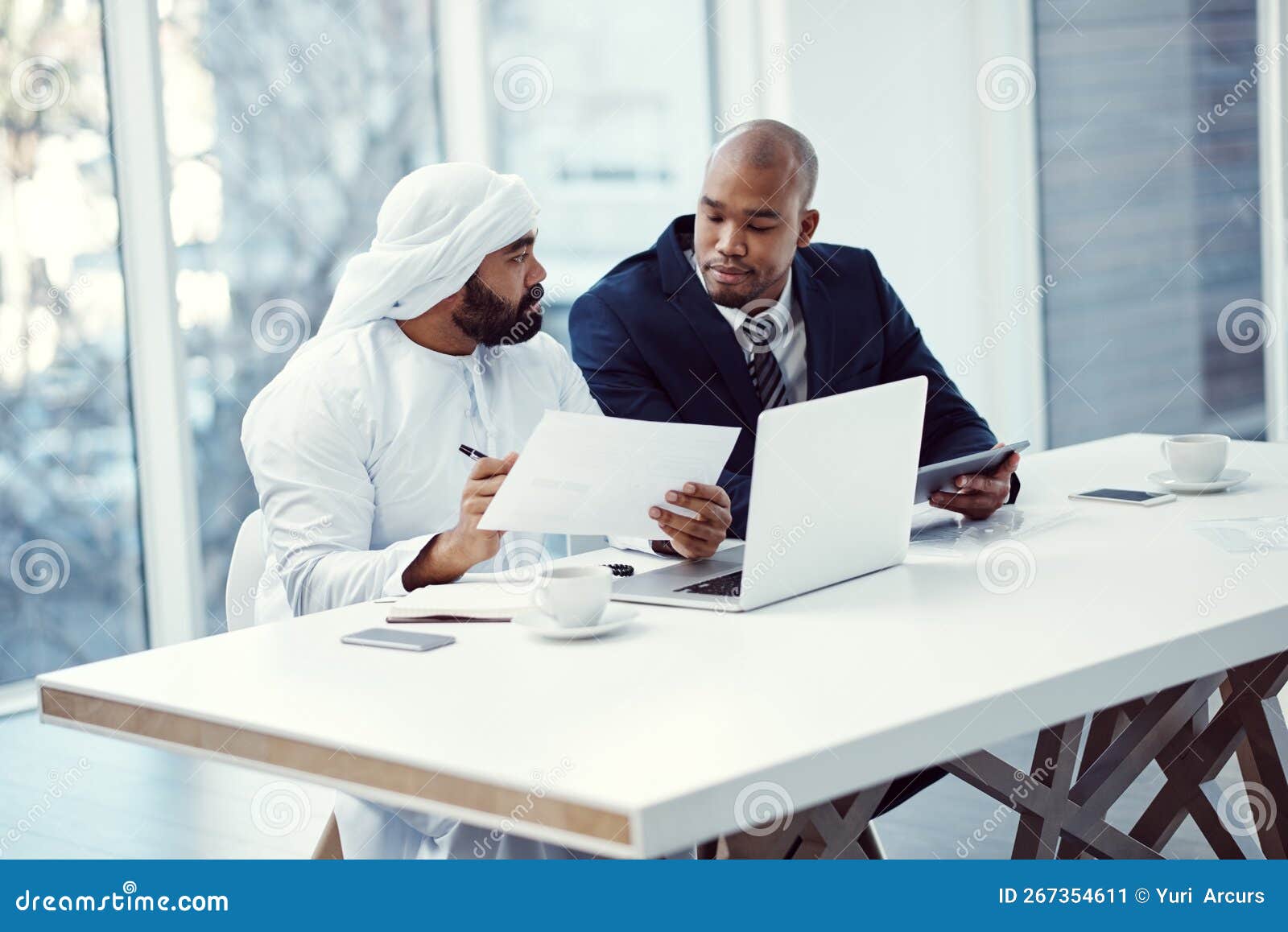 Completing a Business Task in Tandem. Two Businessmen Using a Digital ...