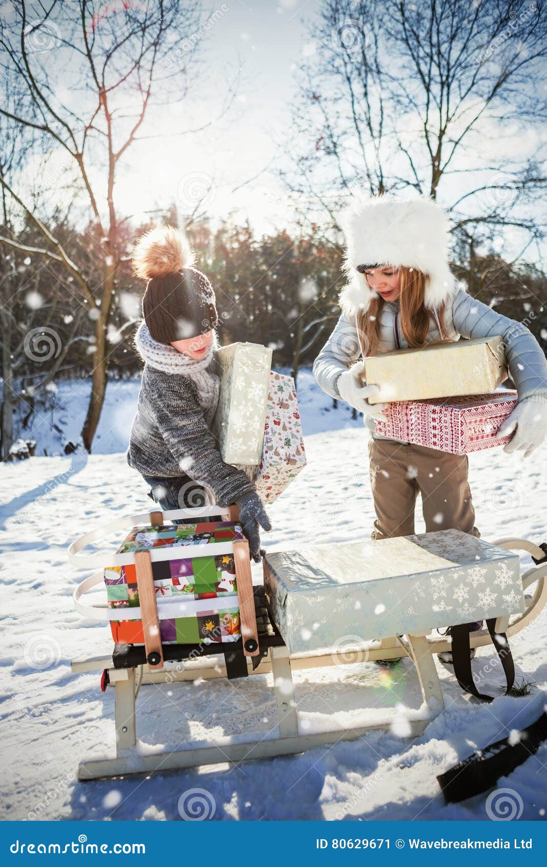 Composite Image of Brother and Sister Keeping Presents on Sledge Stock ...