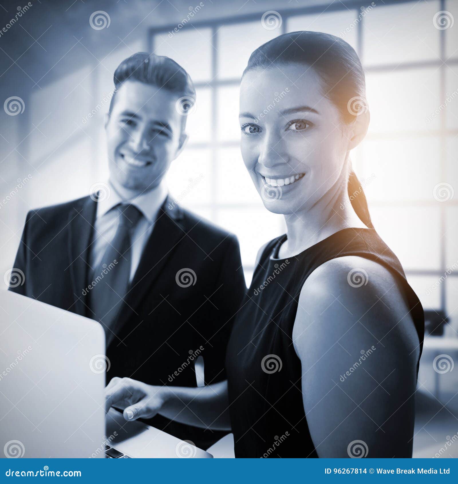 Composite Image of Business People Standing with a Laptop Stock Photo ...