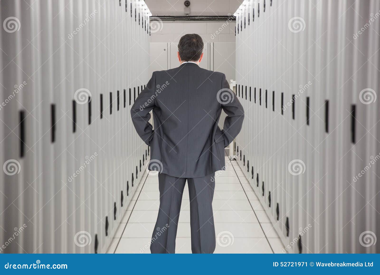 Composite Image of Businessman Standing Back To the Camera with Hands ...