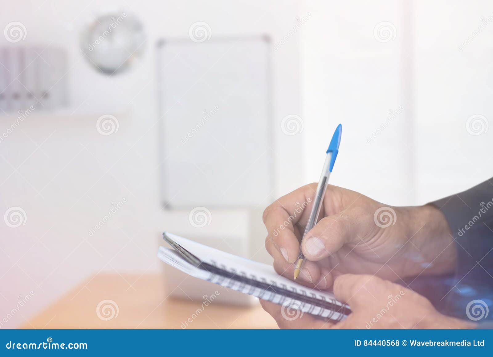 Composite Image of Close Up of Man Writing in Spiral Book Stock Photo ...