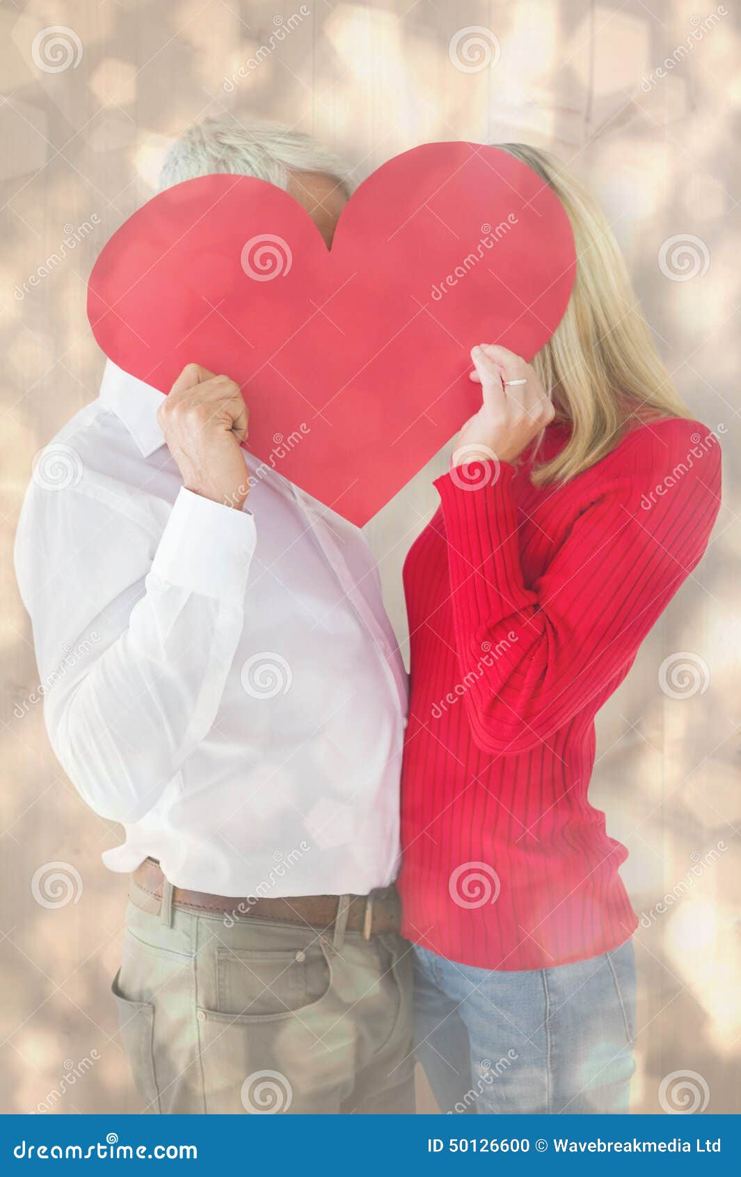 Composite Image of Couple Embracing and Holding Heart Over Faces Stock ...
