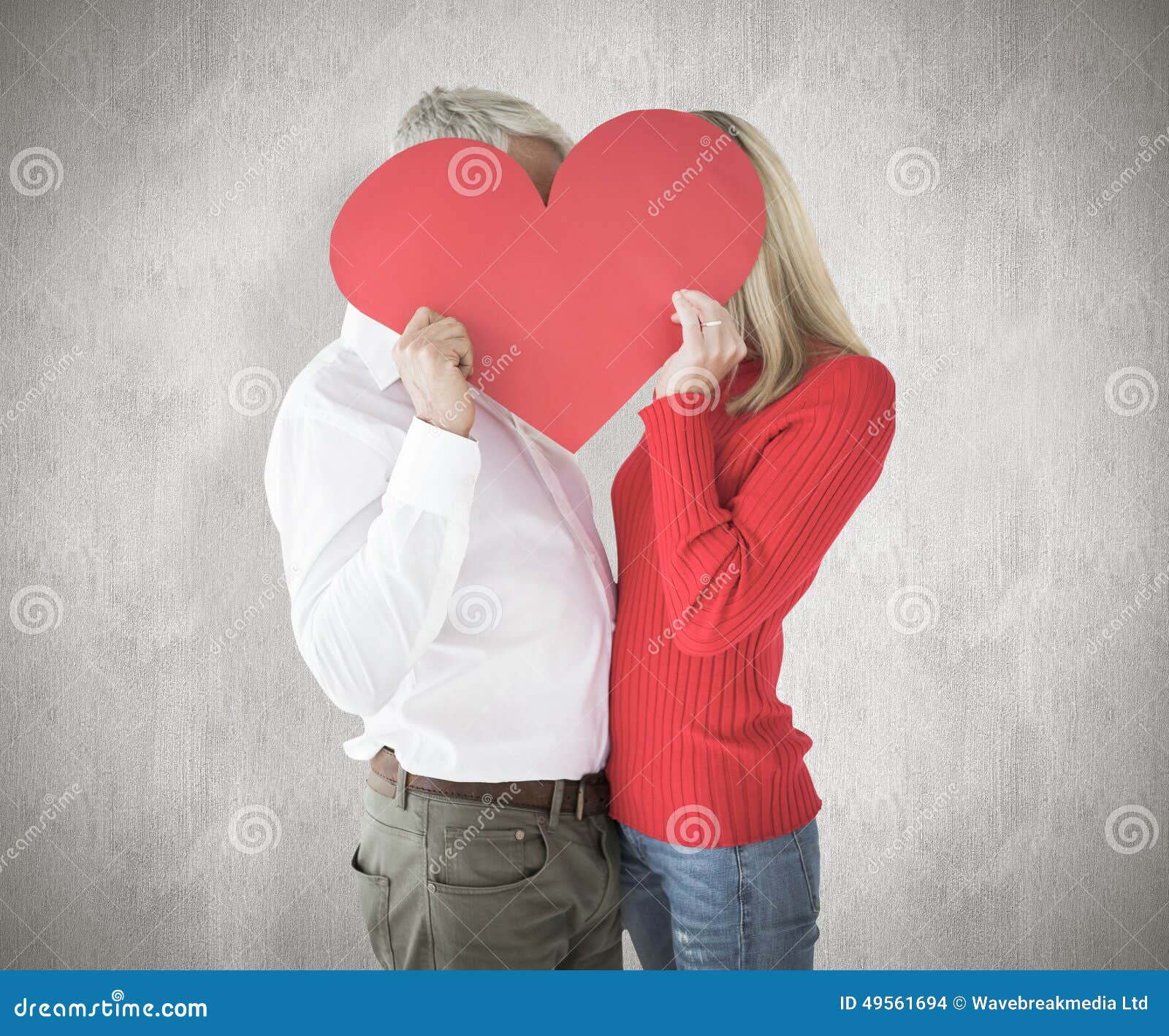 Composite Image of Couple Embracing and Holding Heart Over Faces Stock ...