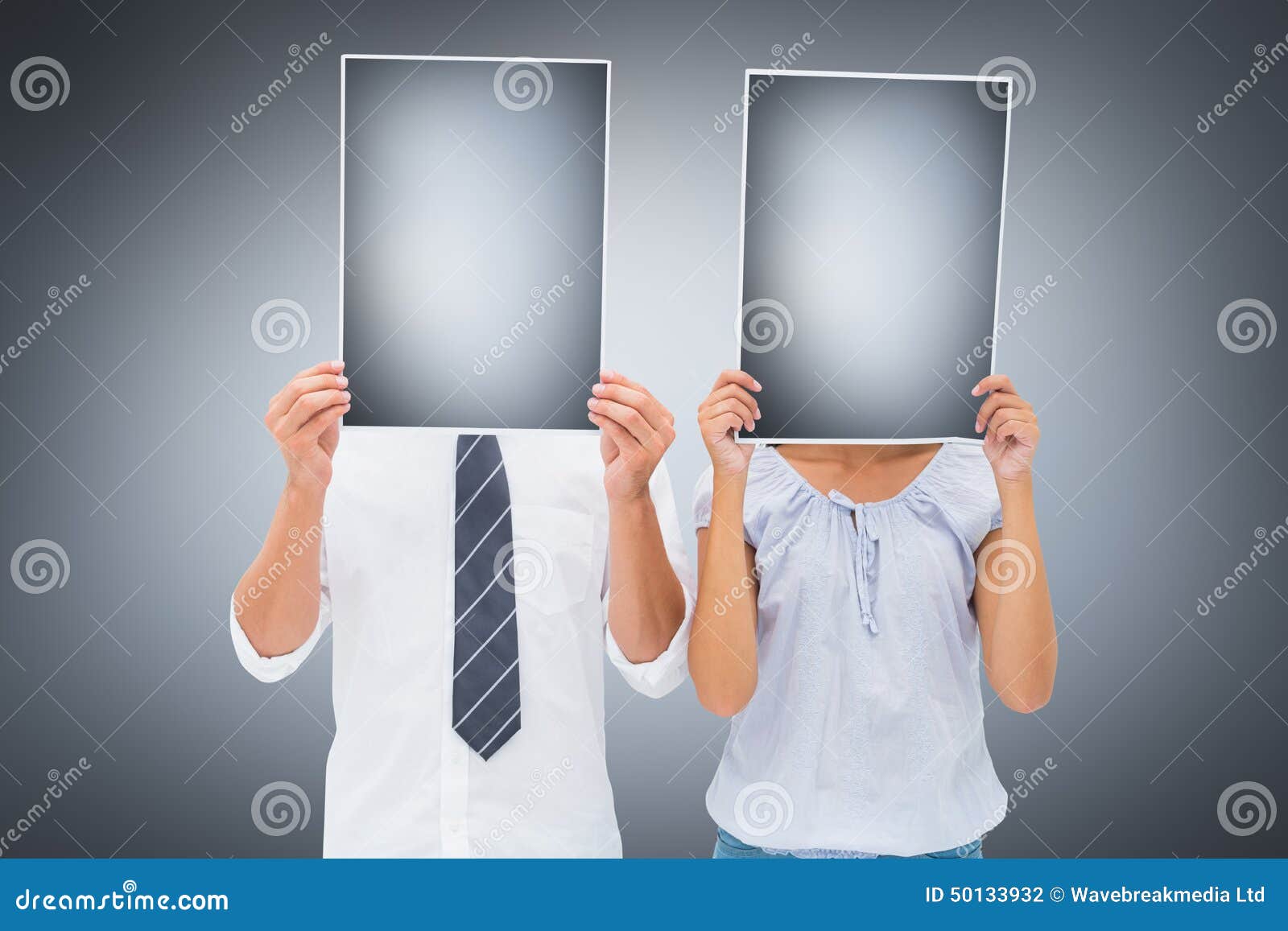 Composite Image of Couple Holding Paper Over Their Faces Stock Photo ...