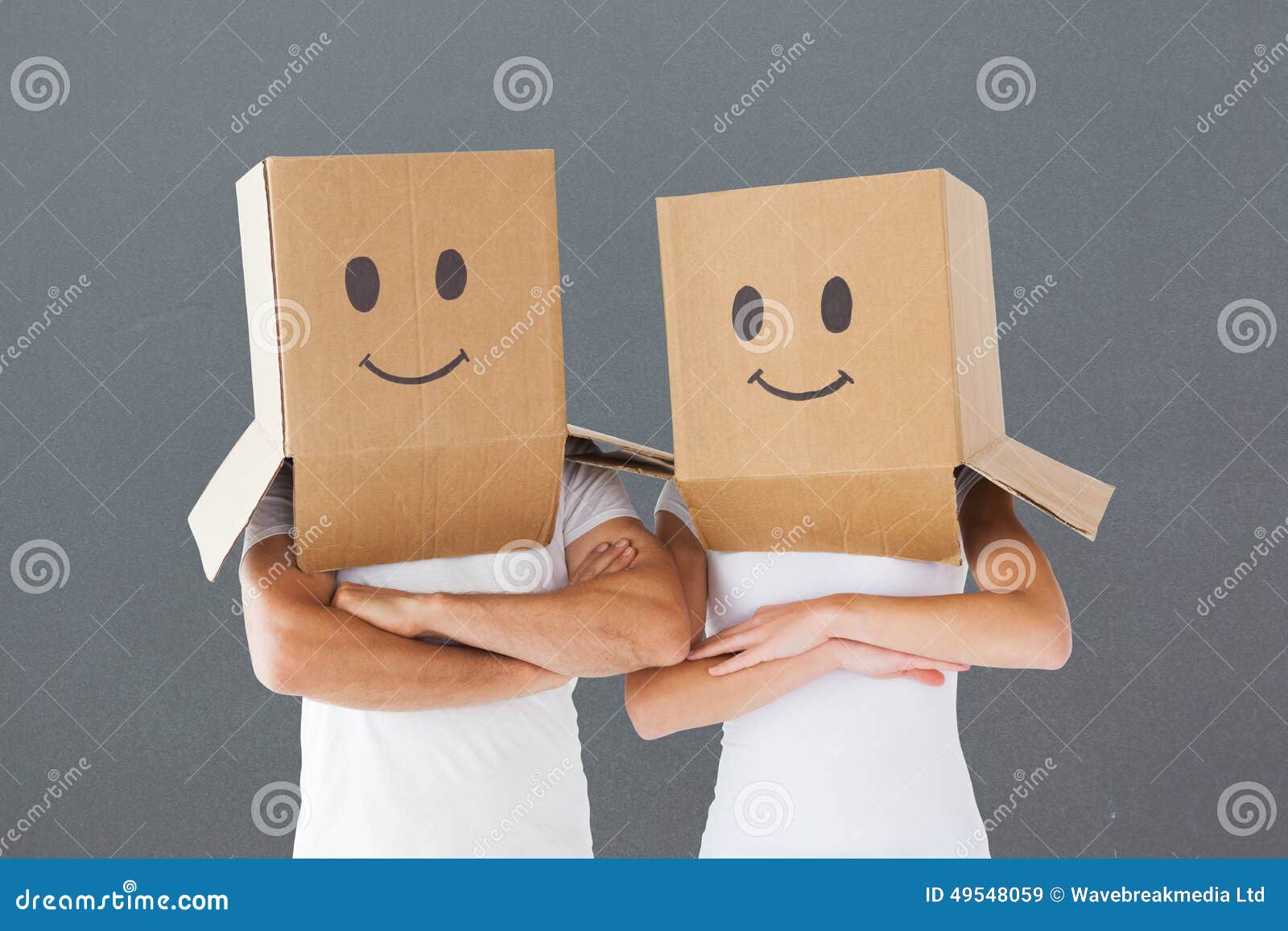 Composite Image of Couple Wearing Smiley Face Boxes on Their Heads ...