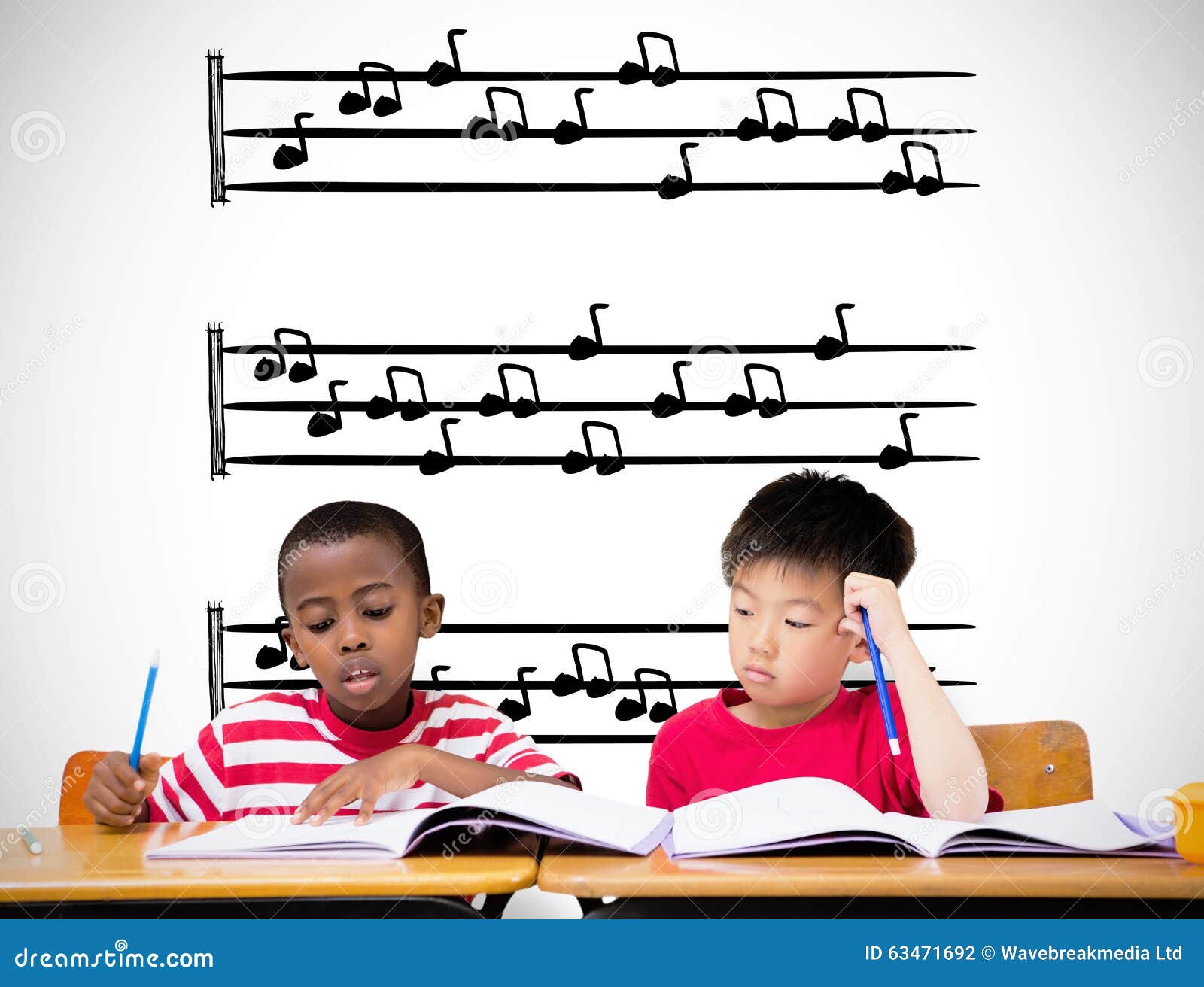 Composite Image of Cute Pupils Writing at Desk in Classroom Stock Photo ...