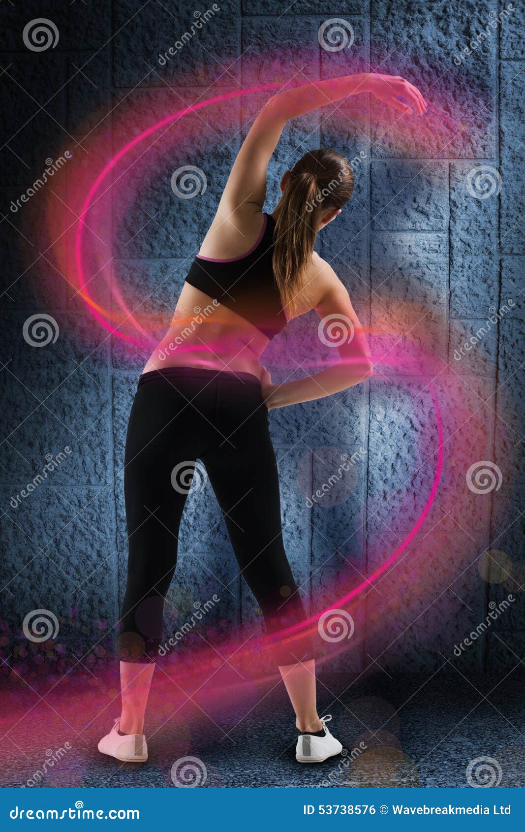 Composite Image of Fit Brunette Stretching Rear View Stock Photo ...