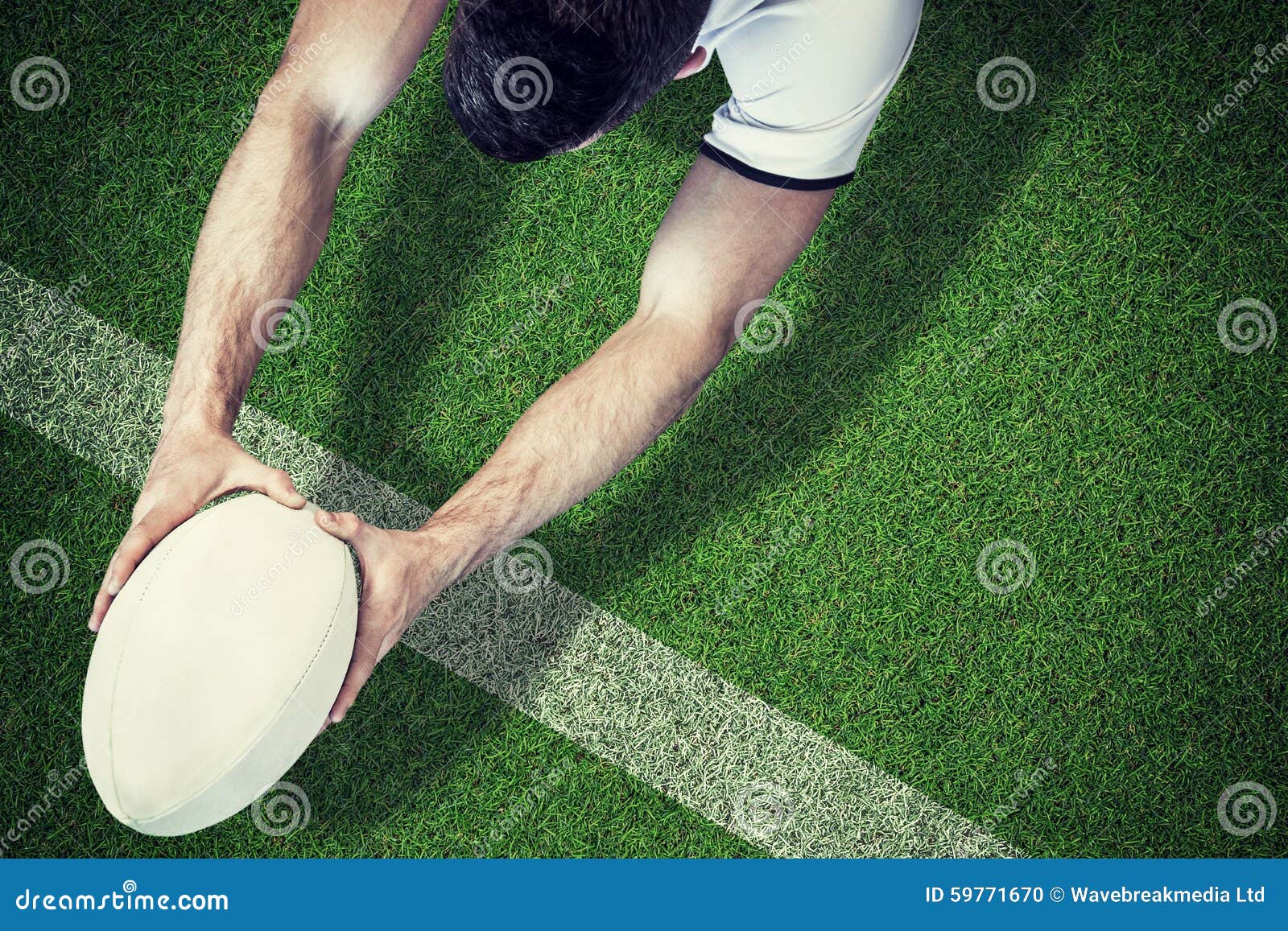 Composite Image of High Angle View of Man Holding Rugby Ball with Both ...