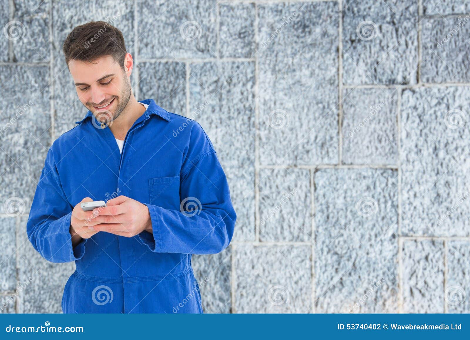 Composite Image of Male Mechanic Text Messaging through Mobile Phone ...