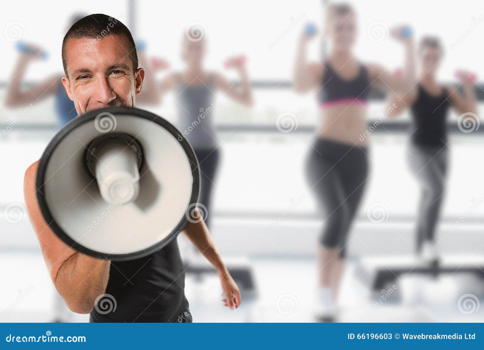Composite Image of Male Trainer Yelling through Megaphone Stock Image ...