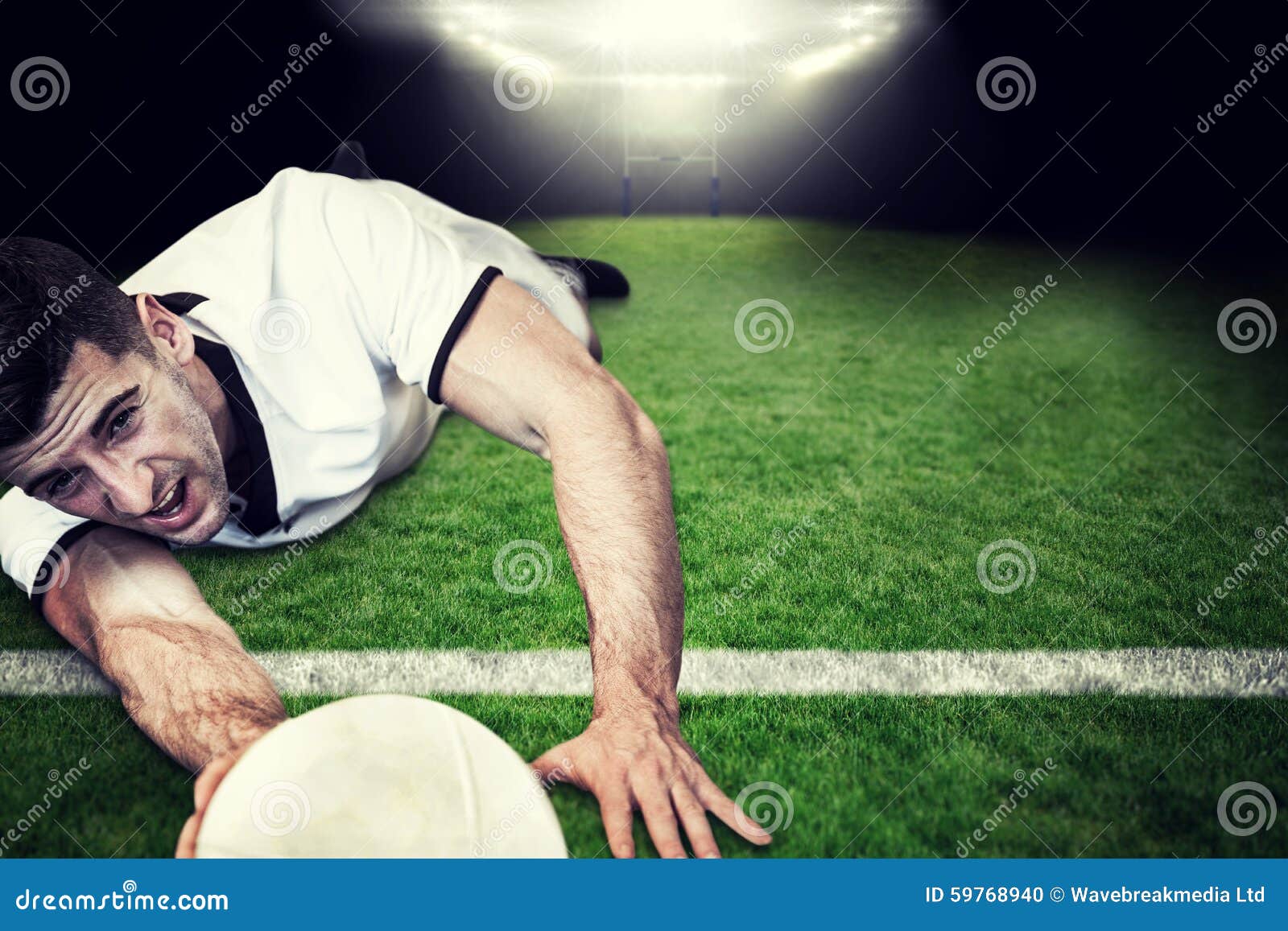 Composite Image of Man Holding Rugby Ball while Lying Down Stock Photo ...