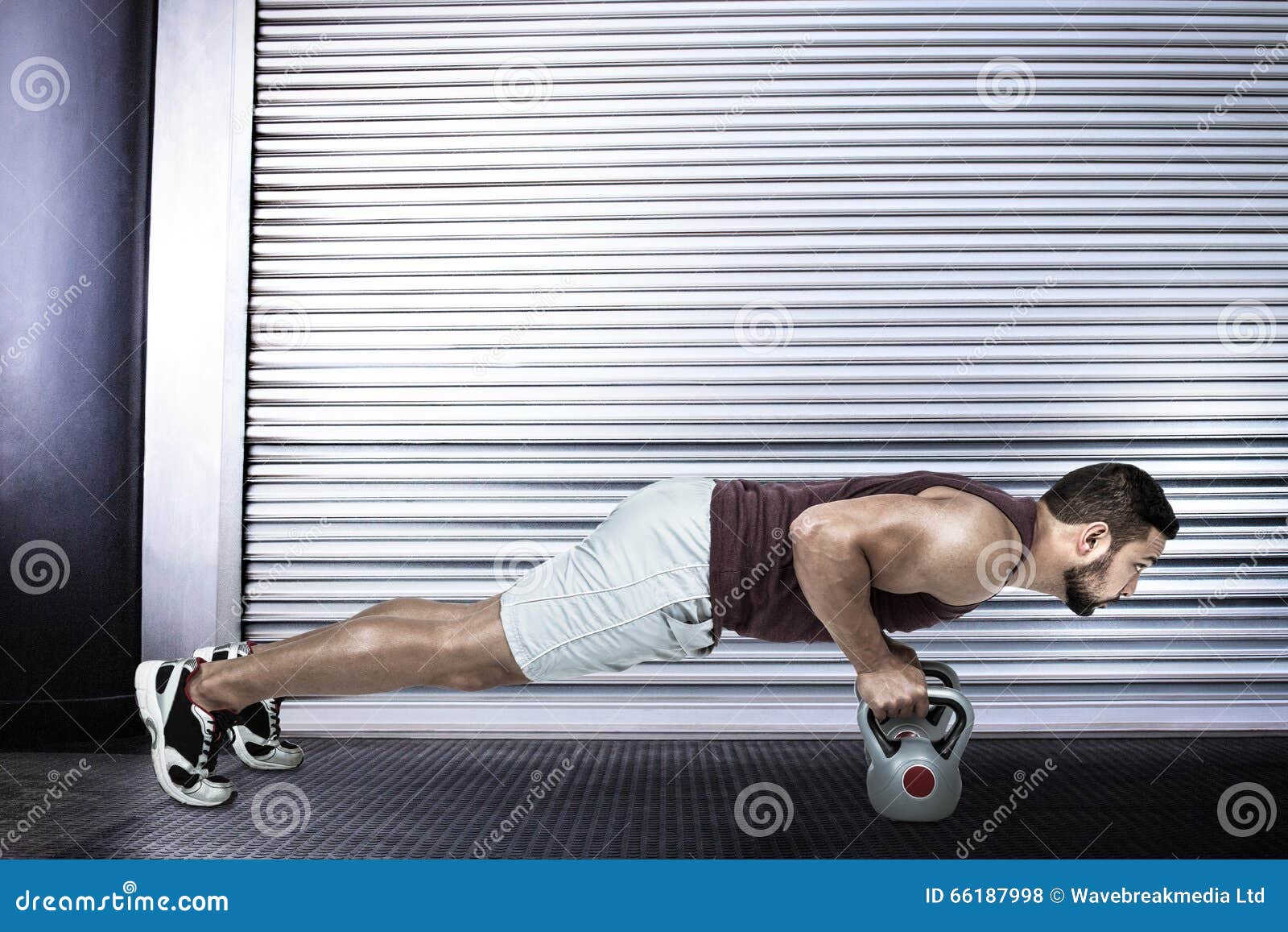 Composite Image of Muscular Man Doing Push Ups with Kettlebells Stock ...