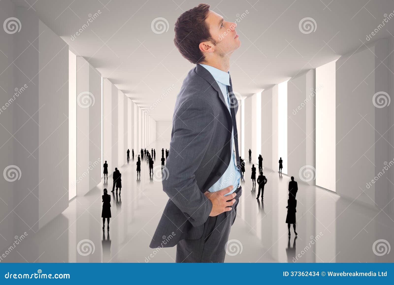 Composite Image of Serious Businessman Standing with Hands on Hips ...