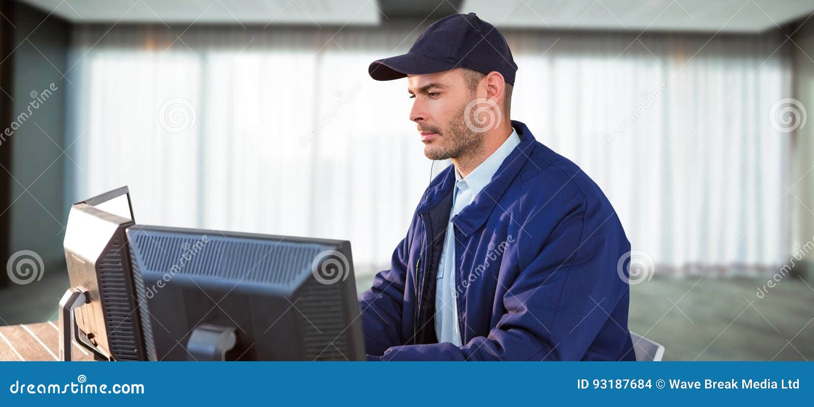 Composite Image of Serious Security Officer Using Computer Stock Photo ...