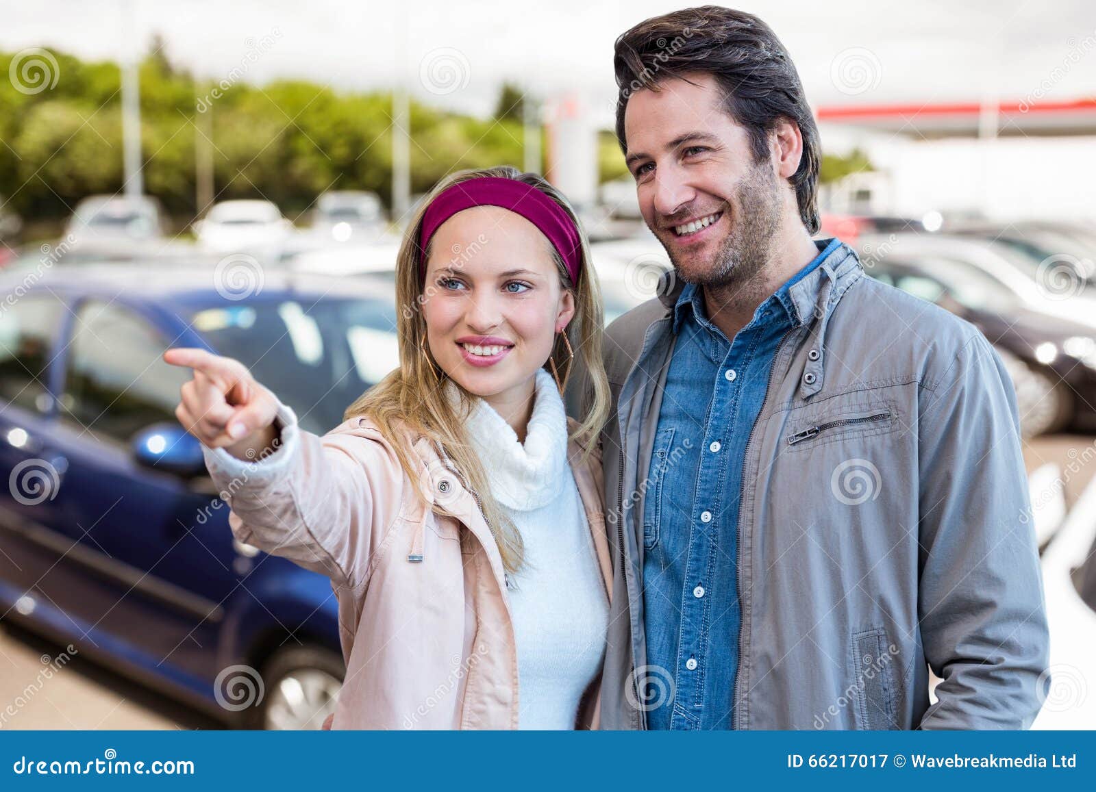Composite Image of Smiling Couple Looking and Pointing Stock Image ...