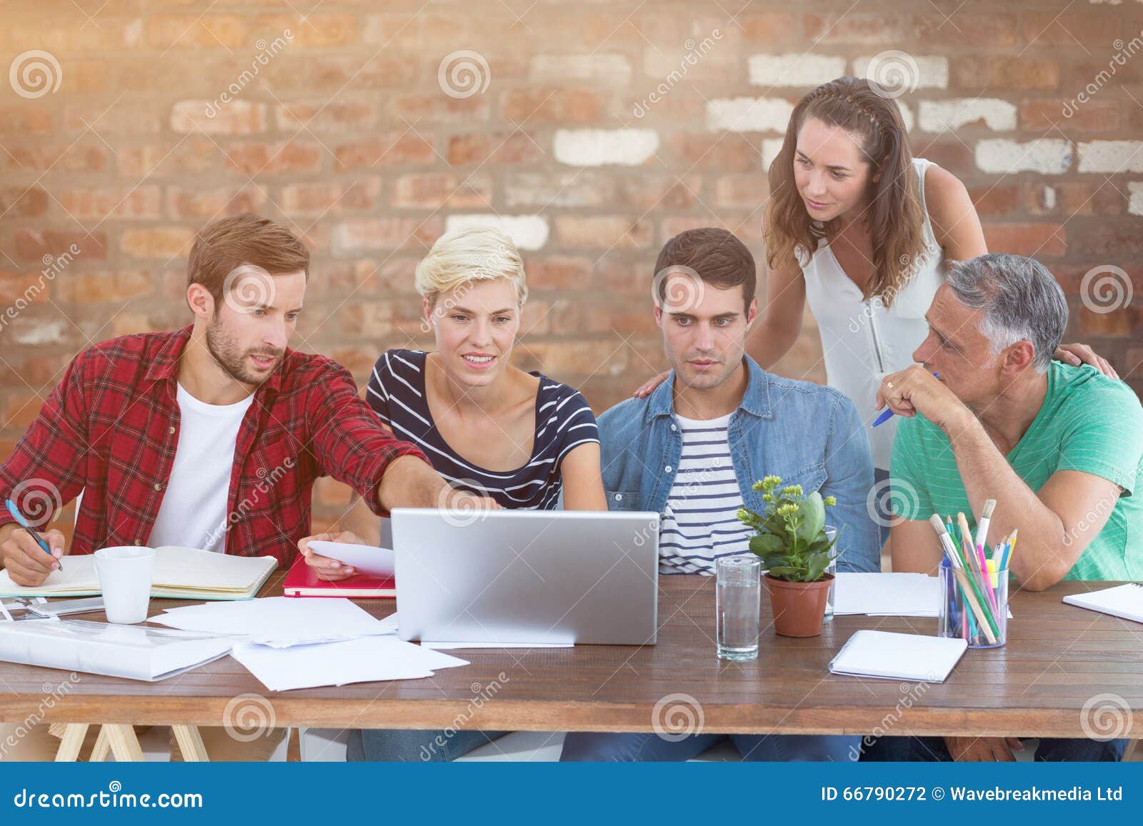 Composite Image of Teamwork Using Laptop Together Stock Photo - Image ...