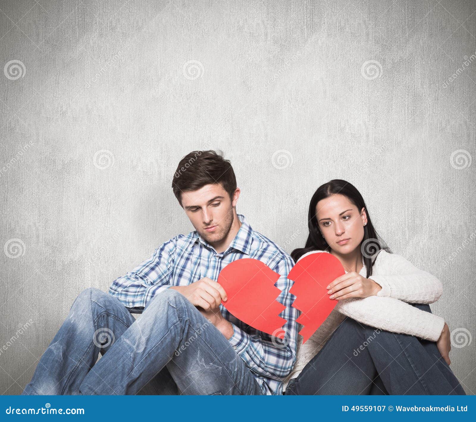 Composite Image of Young Couple Sitting on Floor with Broken Heart ...