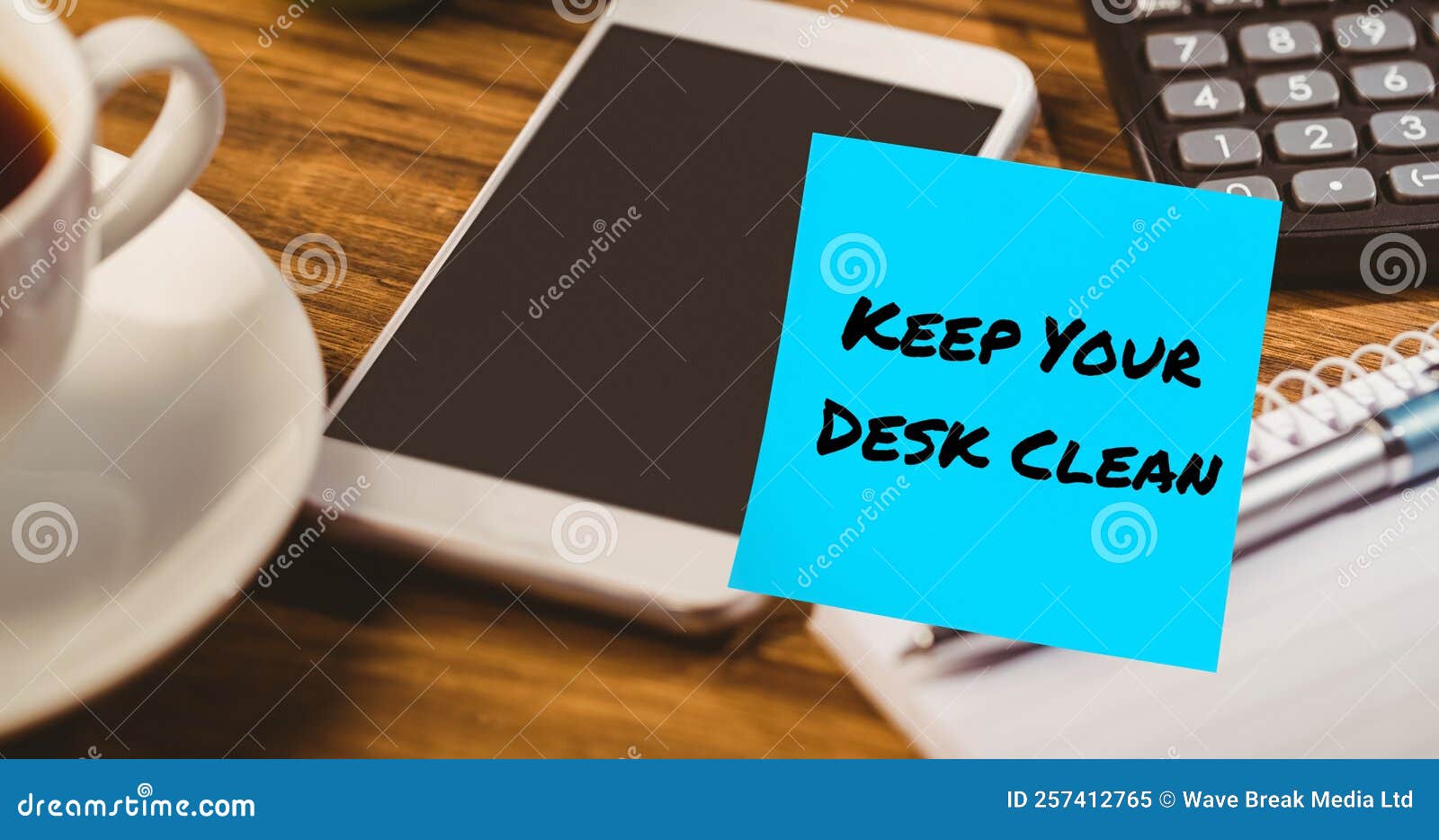 Composite of Keep Your Desk Clean Text on Blue Sticky Note with ...