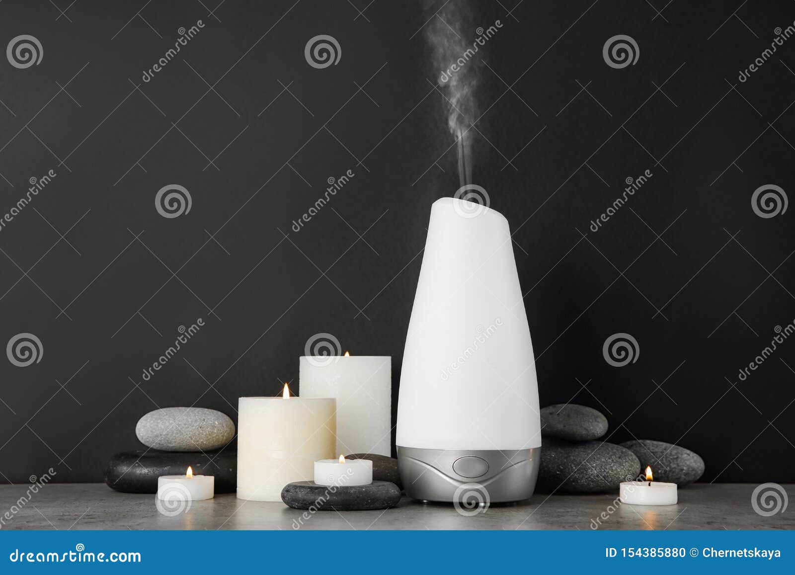 Composition with Aroma Humidifier on Table Against Black Background ...