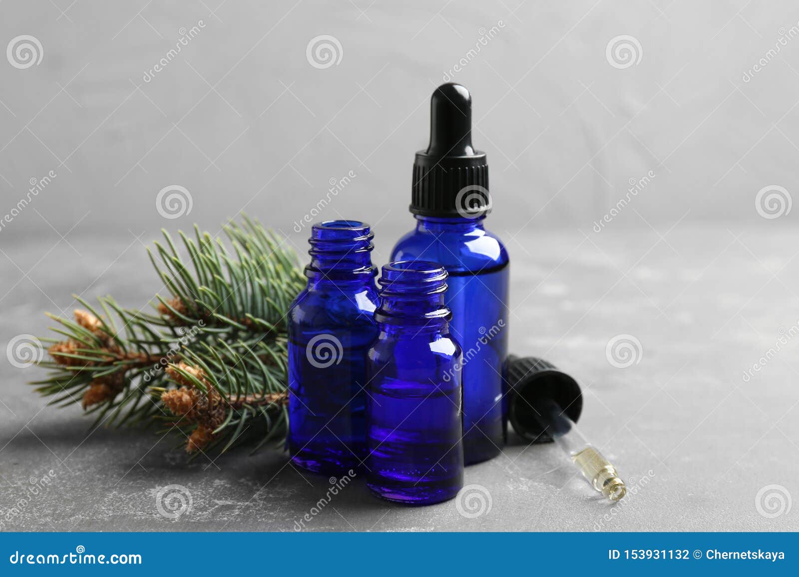 Composition with Bottles of Conifer Essential Oil Stock Photo - Image ...