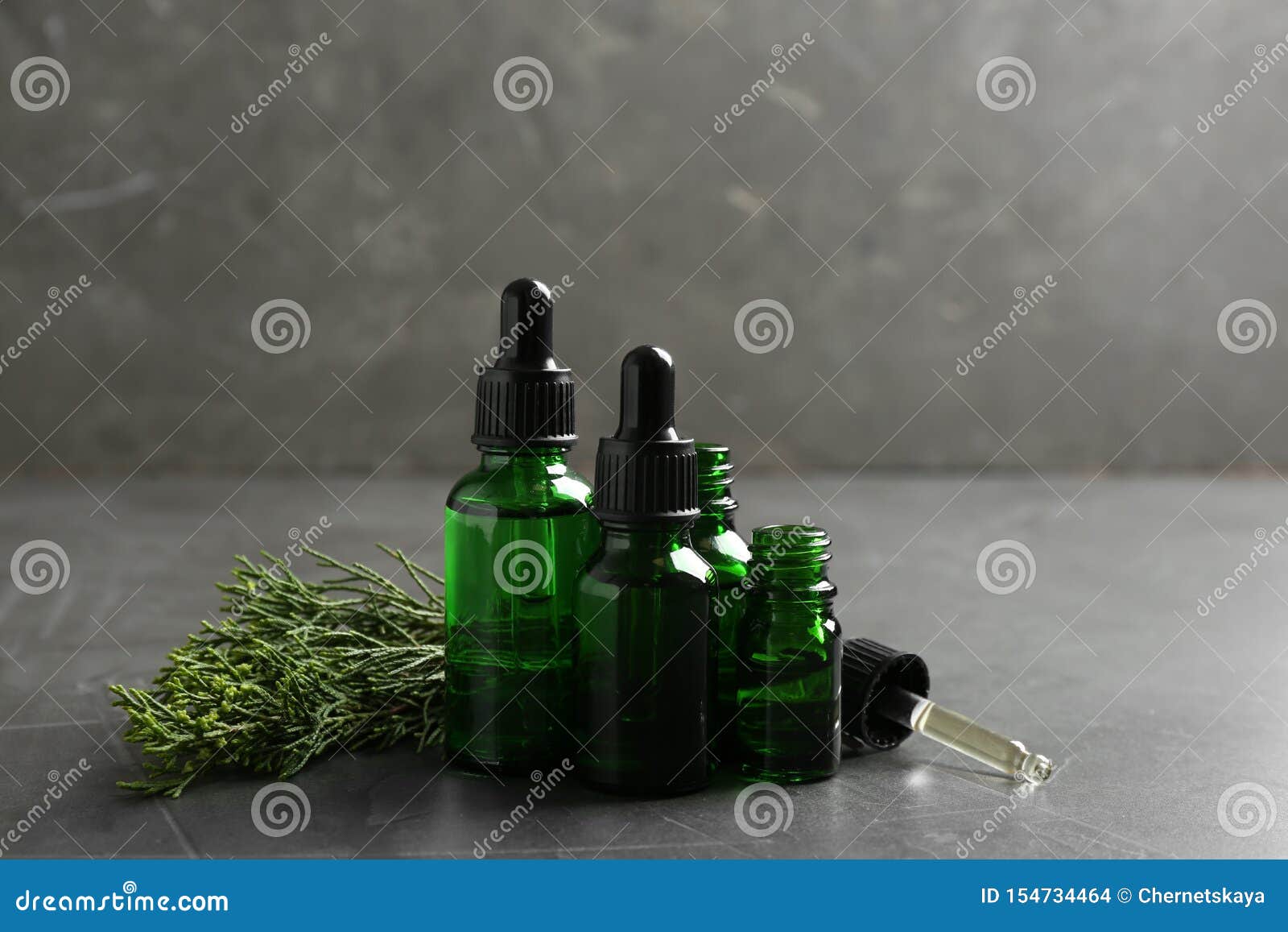 Composition with Bottles of Conifer Essential Oil on Grey Stock Photo ...