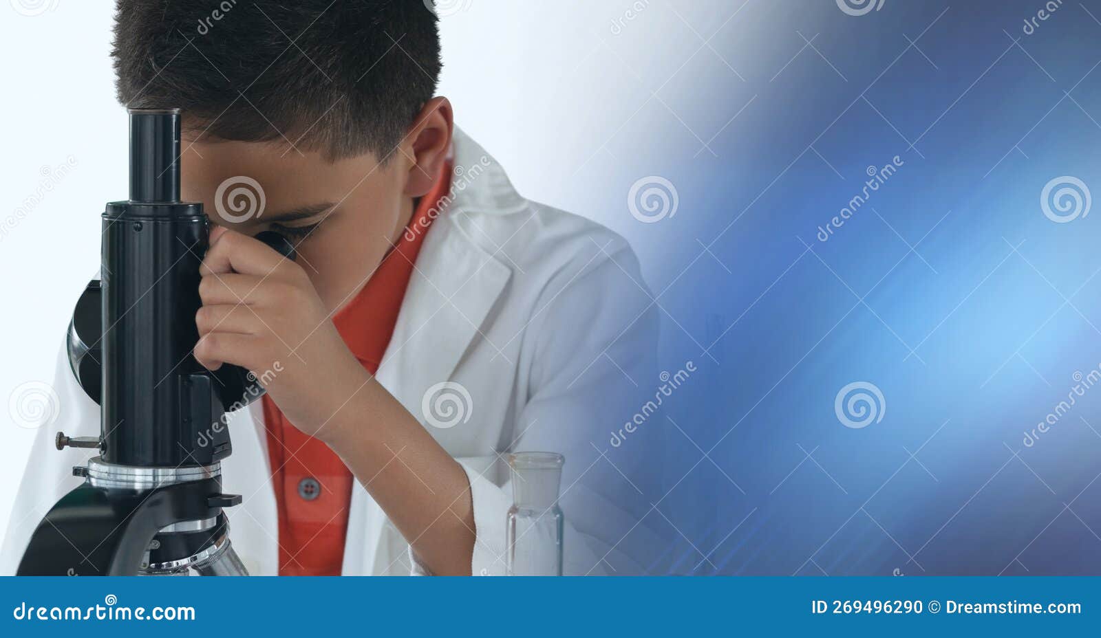 Composition of Boy Using Microscope in Science Class, with Blue Blurred ...