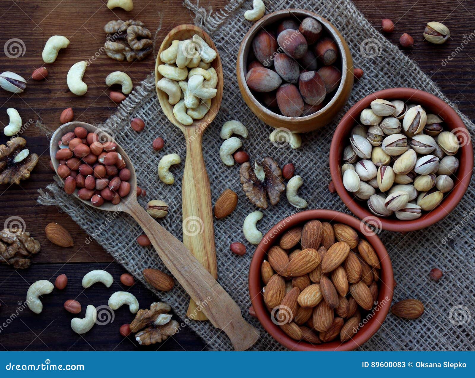 A Composition from Different Varieties of Nuts on a Wooden Background ...