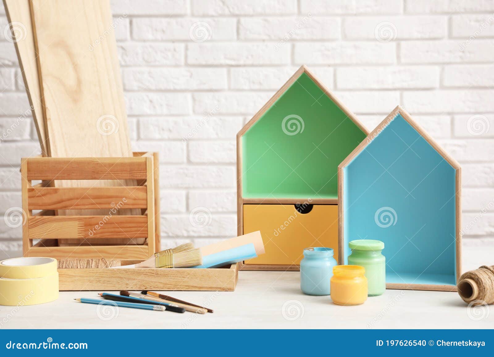 Composition with House Shaped Shelves and Jars of Paints on Table ...
