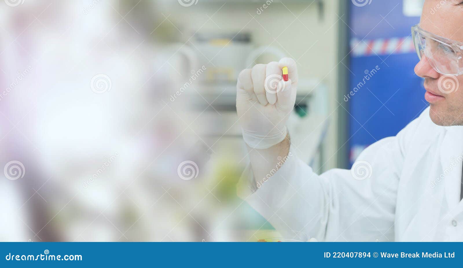 Composition of Male Scientist Holding Pill in Laboratory with Copy ...