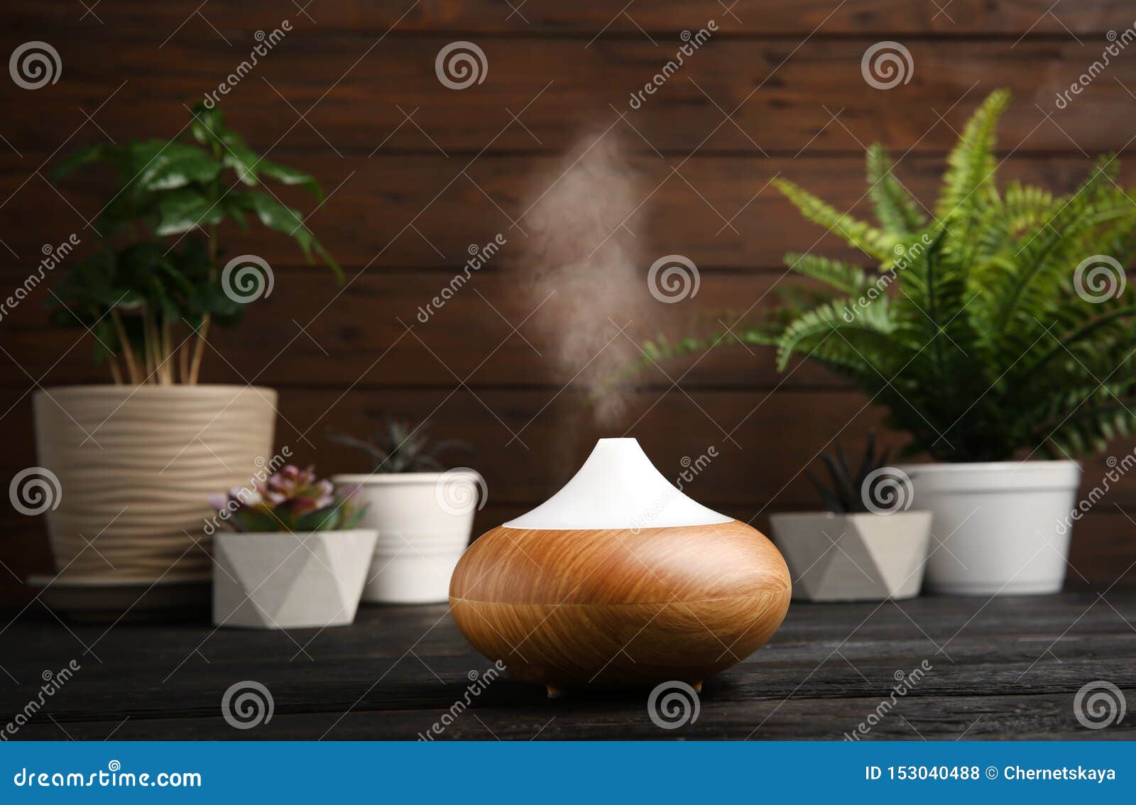 Composition with Modern Essential Oil Diffuser on Black Wooden Table ...