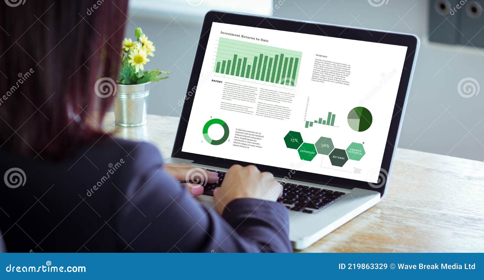 Composition of Person at Desk Using Laptop, with Research Data ...