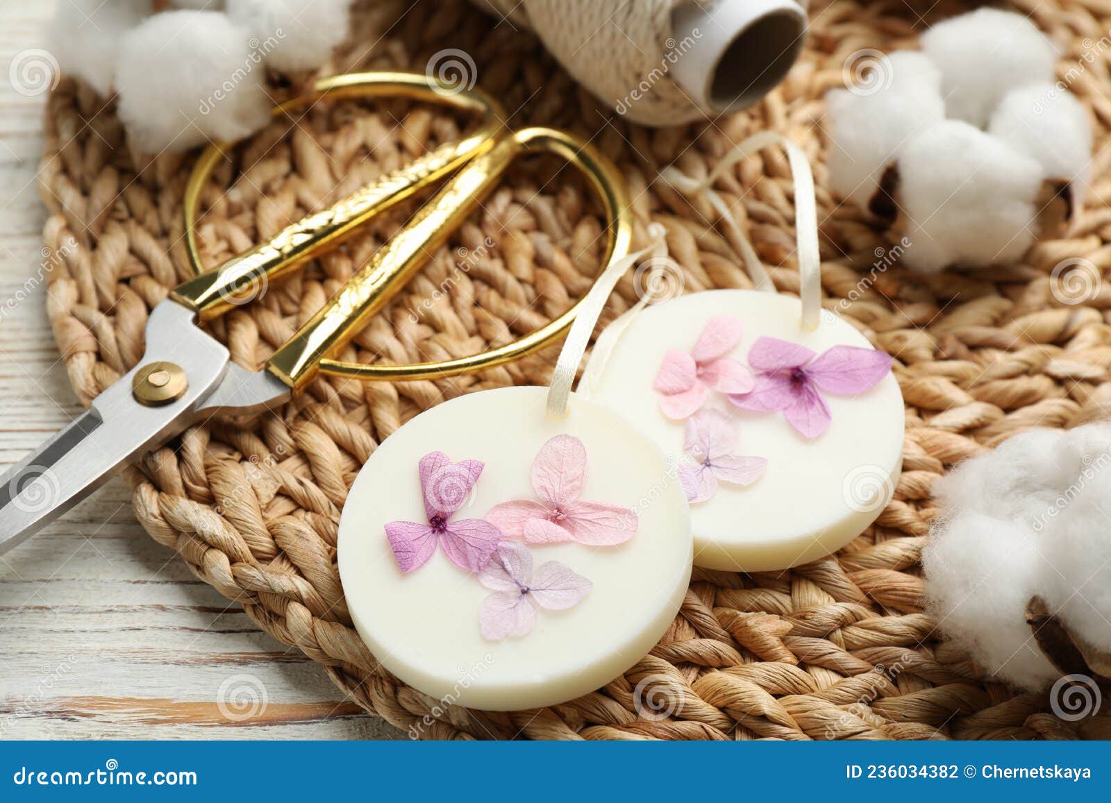Composition with Scented Sachets, Scissors and Flowers on White Wooden ...