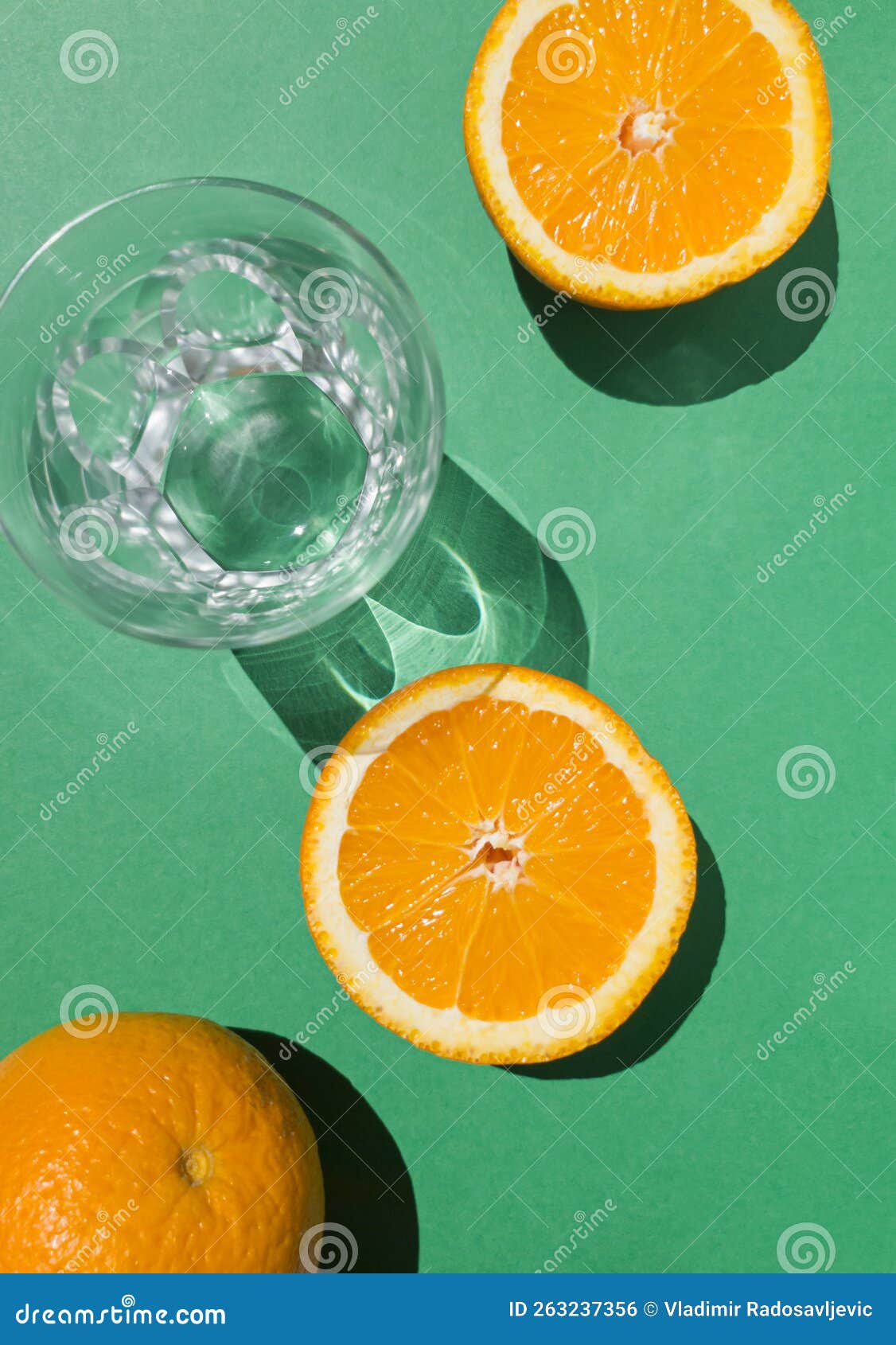 Composition with Sliced Orange Fruit and Empty Glass on Green ...