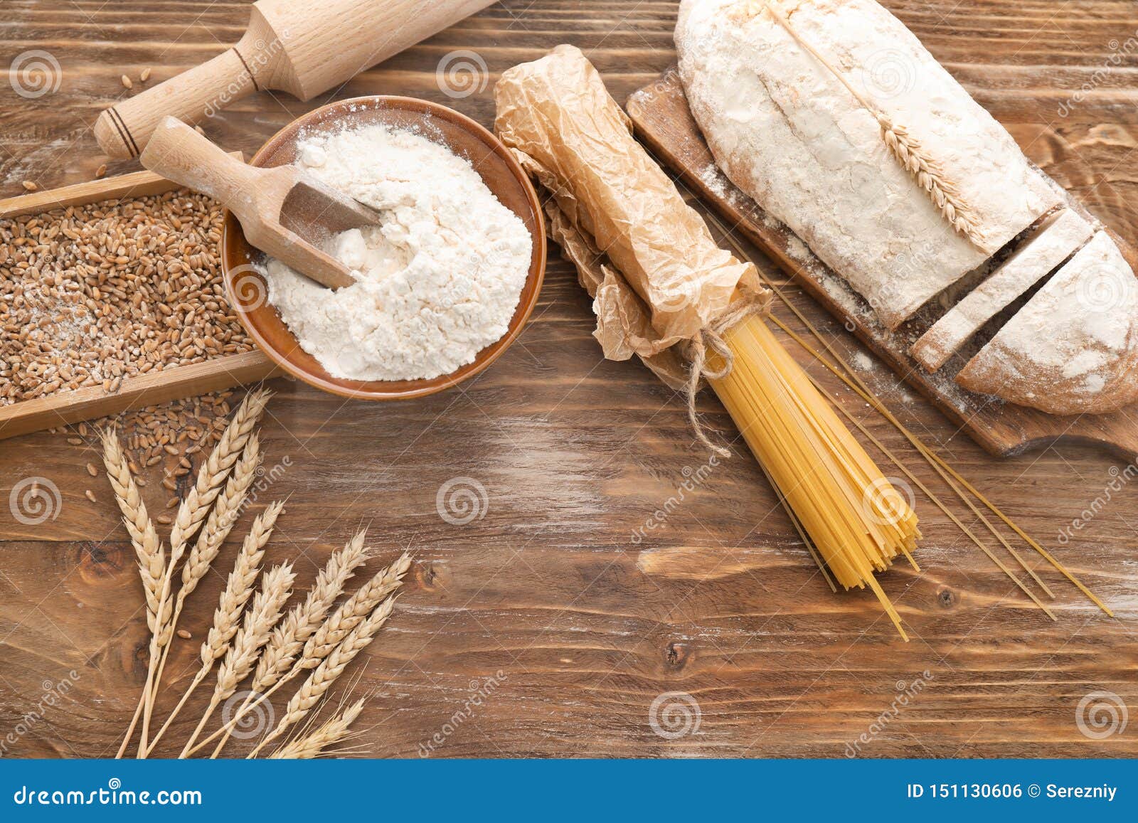 Composition with Wheat Flour, Bread and Pasta on Wooden Background ...