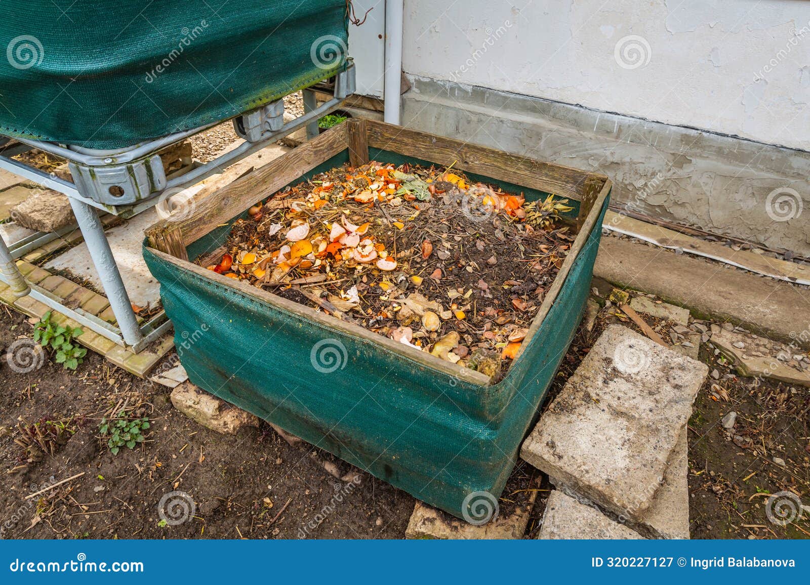 Compost Bin in a Garden, Using Kitchen and Green Waste To Prepare ...