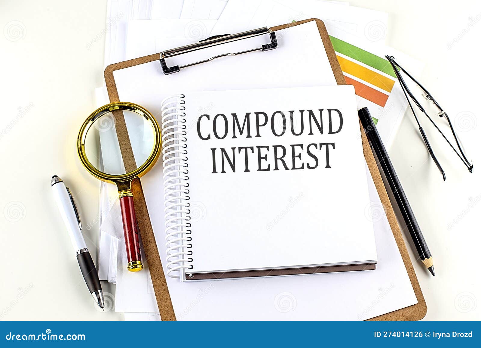 COMPOUND INTEREST Text on Notebook with Clipboard on White Background ...
