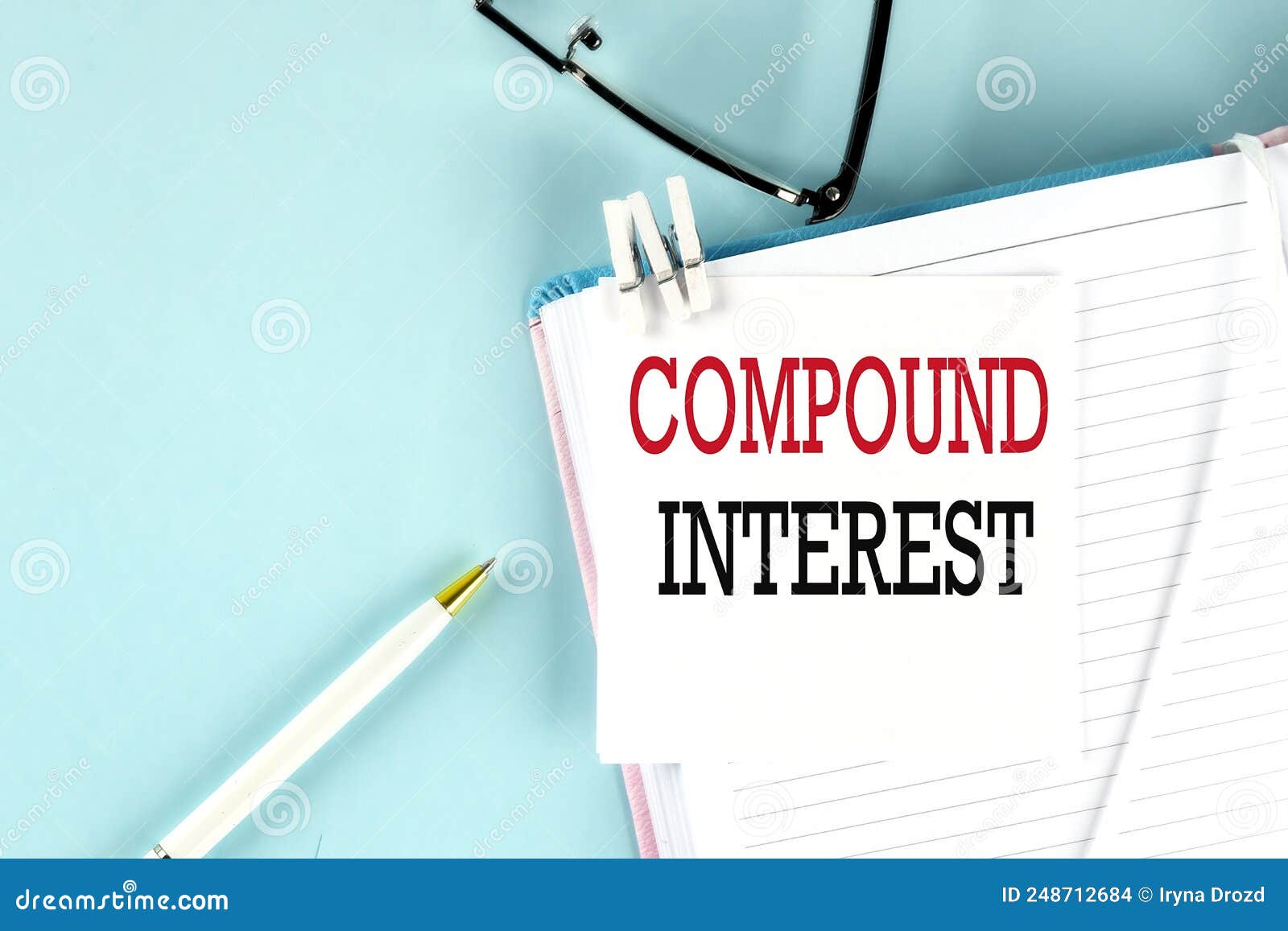 COMPOUND INTEREST Text on a Sticky on Notebook with Pen and Glasses ...