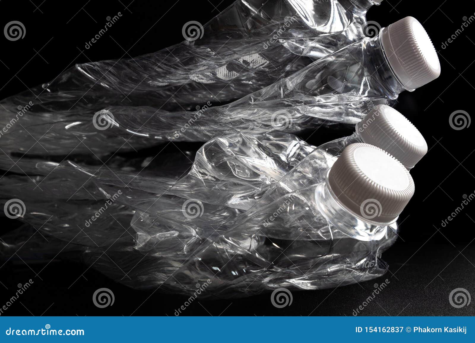 Compressed Plastic Drinking Water Bottle on ISolated Black Background ...