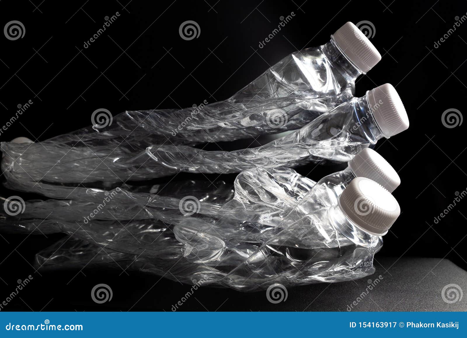Compressed Plastic Drinking Water Bottle on ISolated Black Background ...