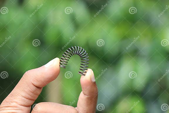 Compression Springs Held in Hand Bent To Show Its Ability To Absorb ...