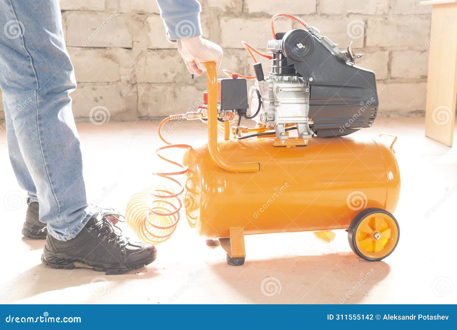 The Compressor is Portable.Using a Portable Compressor at Work Stock ...