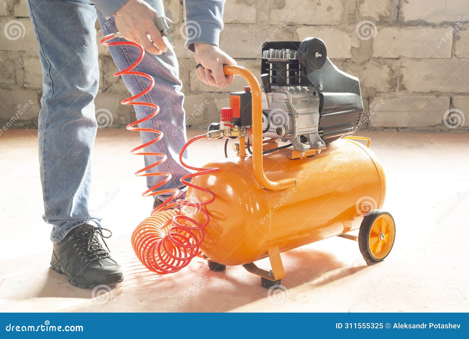 The Compressor is Portable.Using a Portable Compressor at Work Stock ...