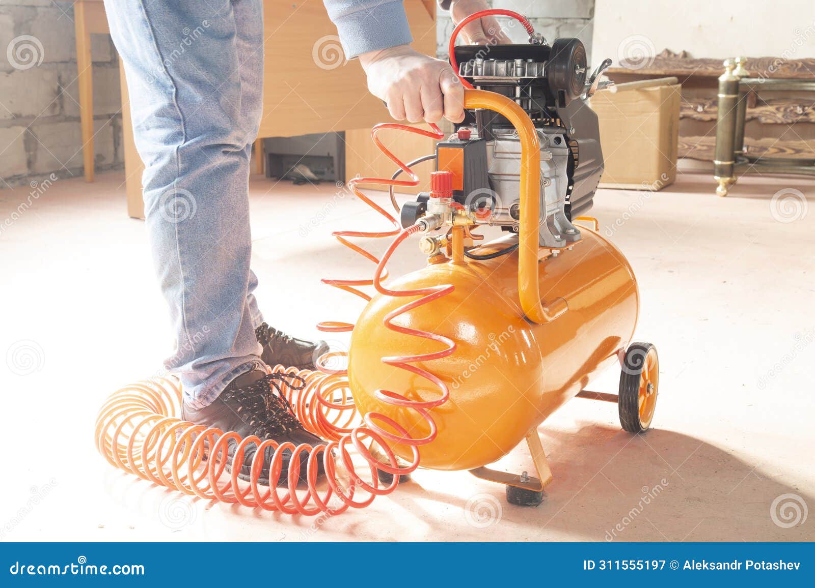 The Compressor is Portable.Using a Portable Compressor at Work Stock ...