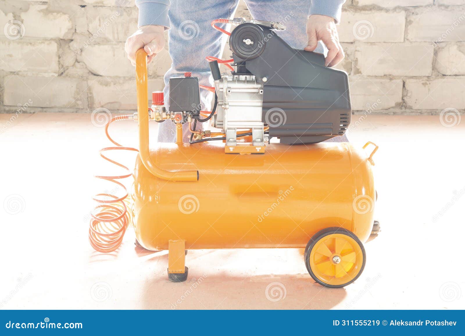 The Compressor is Portable.Using a Portable Compressor at Work Stock ...