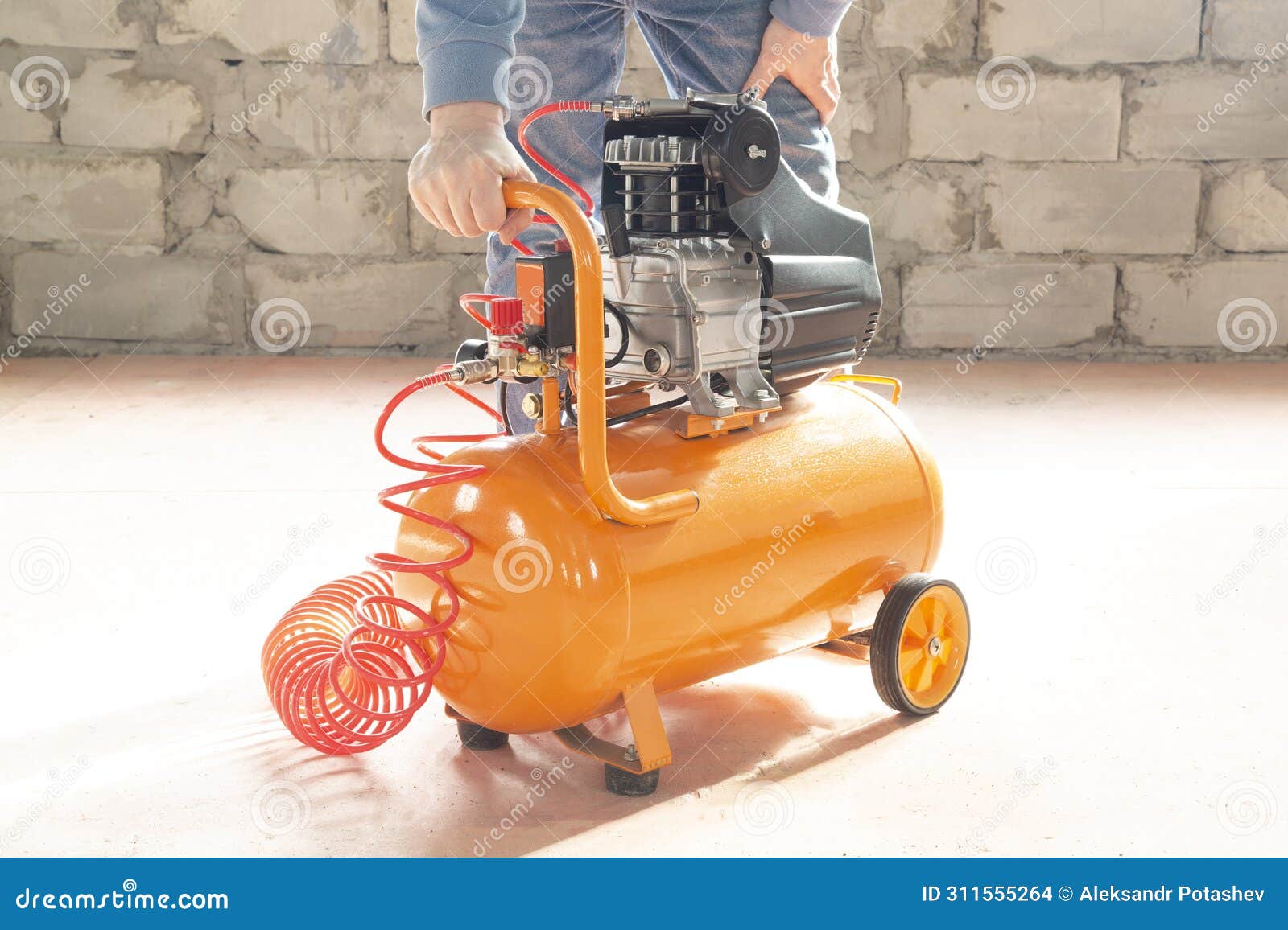 The Compressor is Portable.Using a Portable Compressor at Work Stock ...