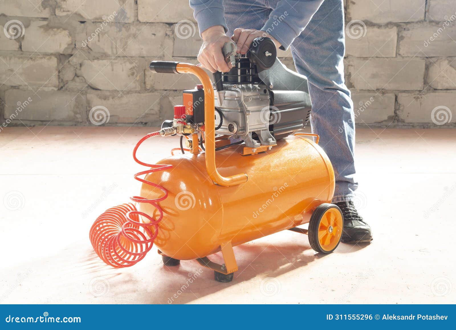 The Compressor is Portable.Using a Portable Compressor at Work Stock ...
