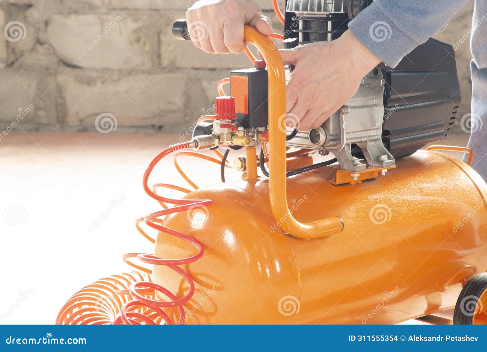 The Compressor is Portable.Using a Portable Compressor at Work Stock ...