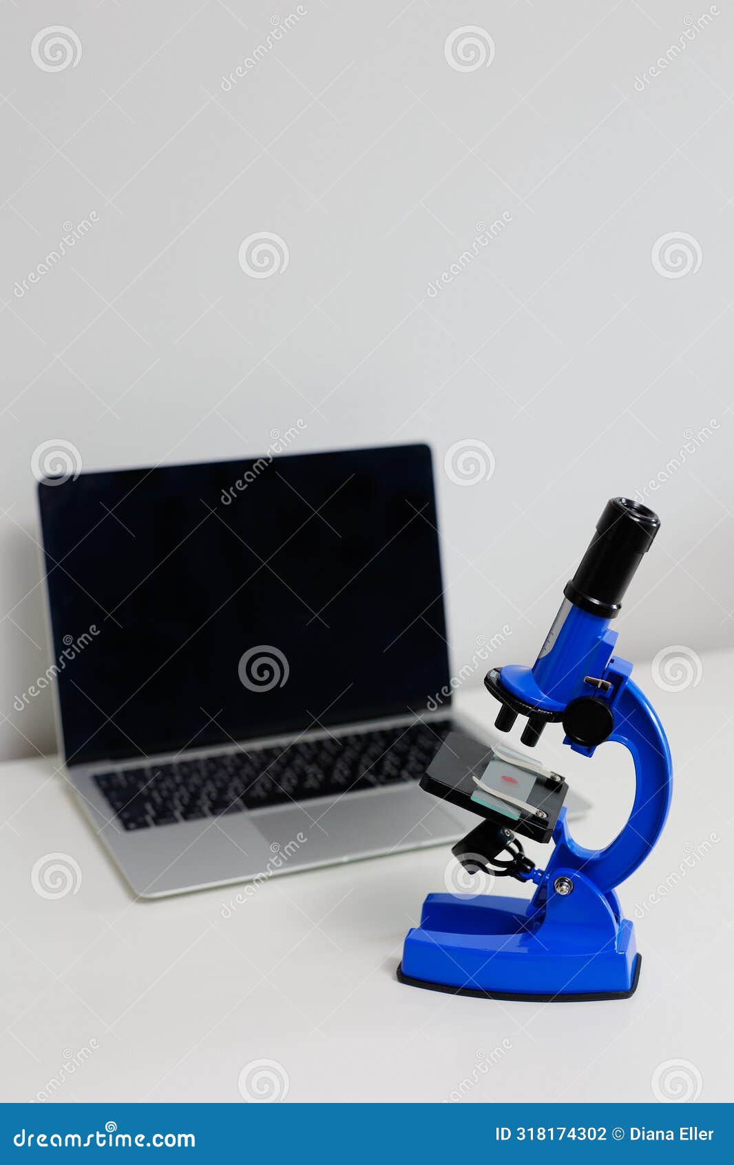 Computer with Black Screen and Blue Microscope on White Table Stock ...